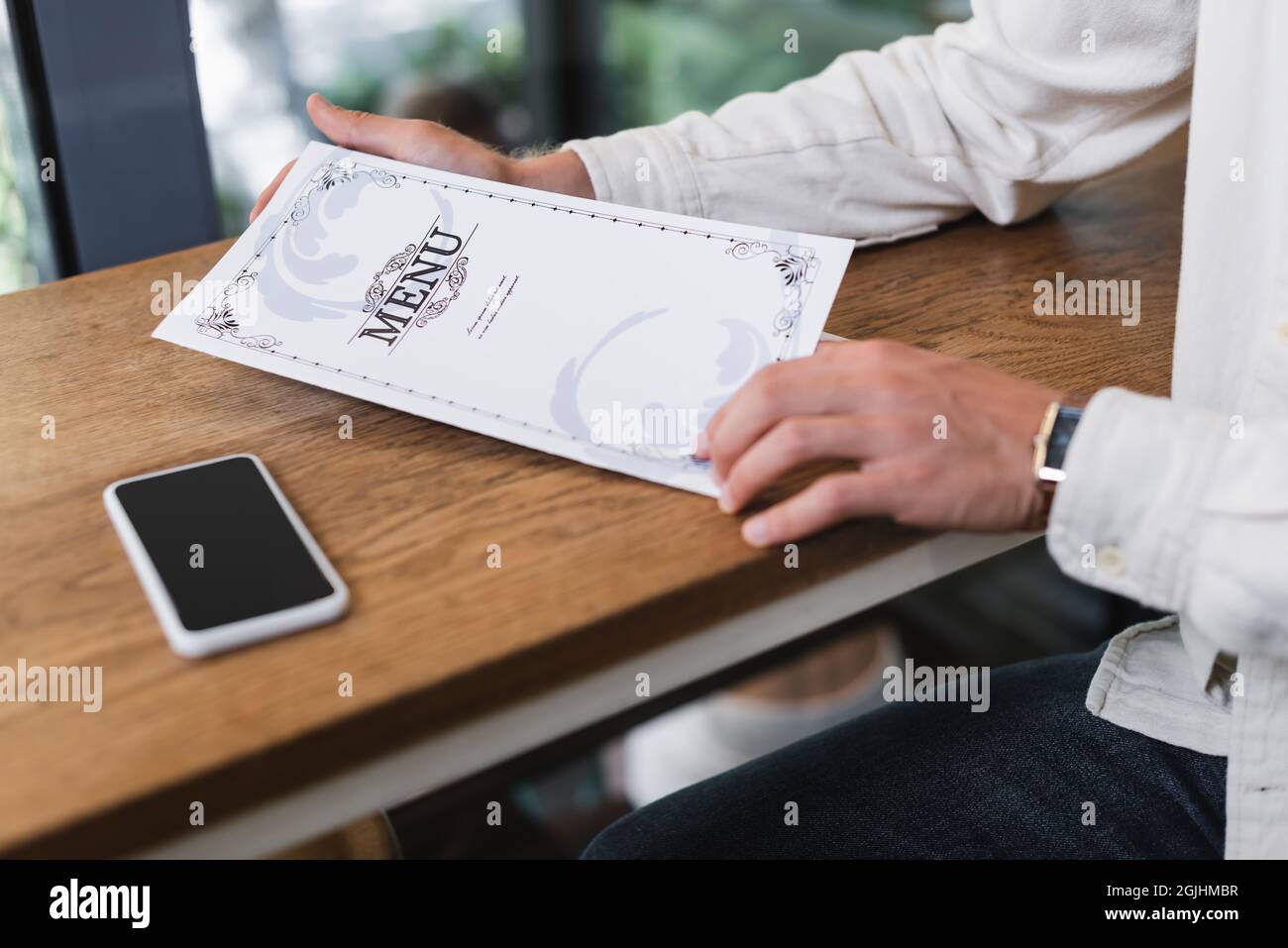 Man holding menu hi-res stock photography and images - Alamy