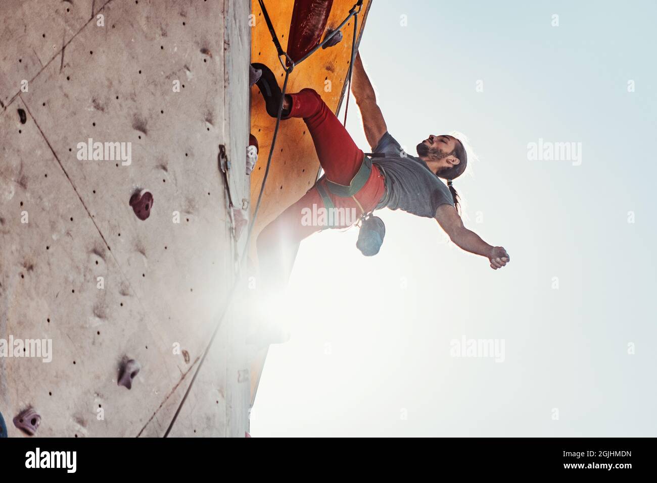 Early morning workouts. One Caucasian man professional rock climber ...