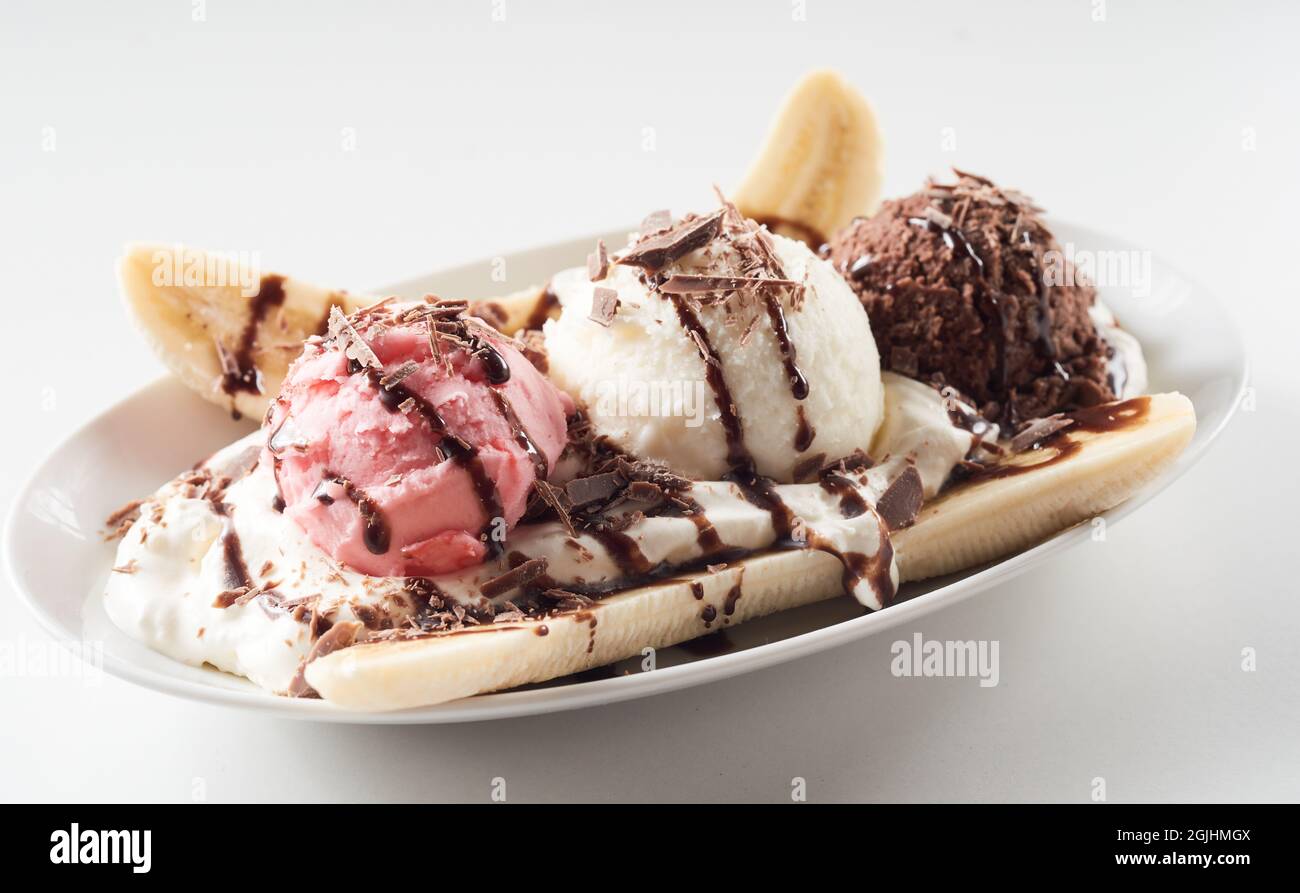 High angle of yummy cold ice cream scoops and slices of banana served ...