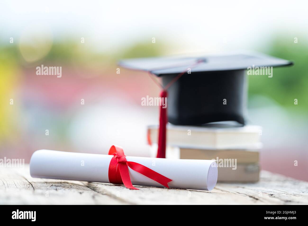 Closeup shot of a graduation cap and diploma degree certificate on a ...
