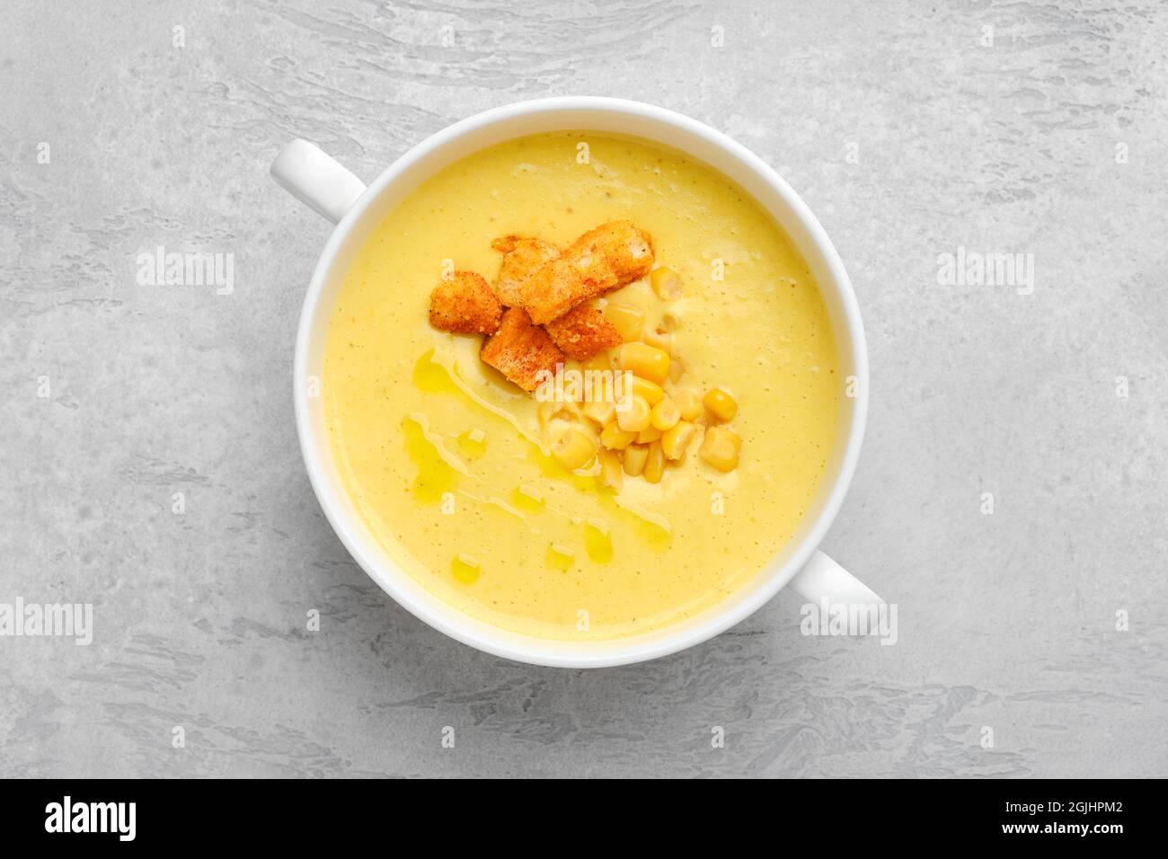 Top view of mashed corn soup puree with croutons Stock Photo - Alamy