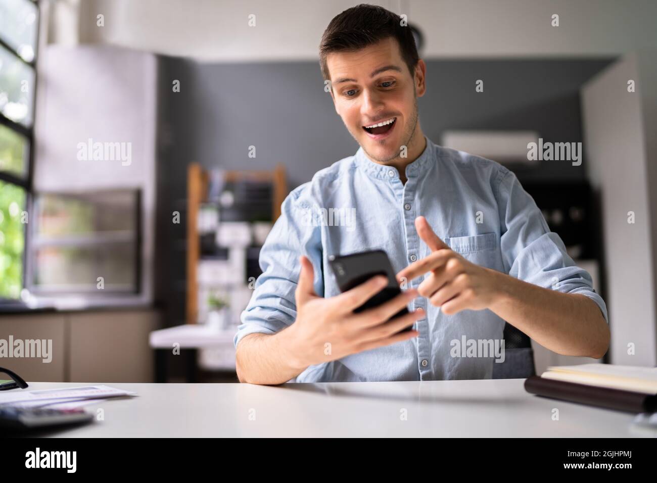 Happy Stock Market Trader Looking At Phone Stock Photo - Alamy