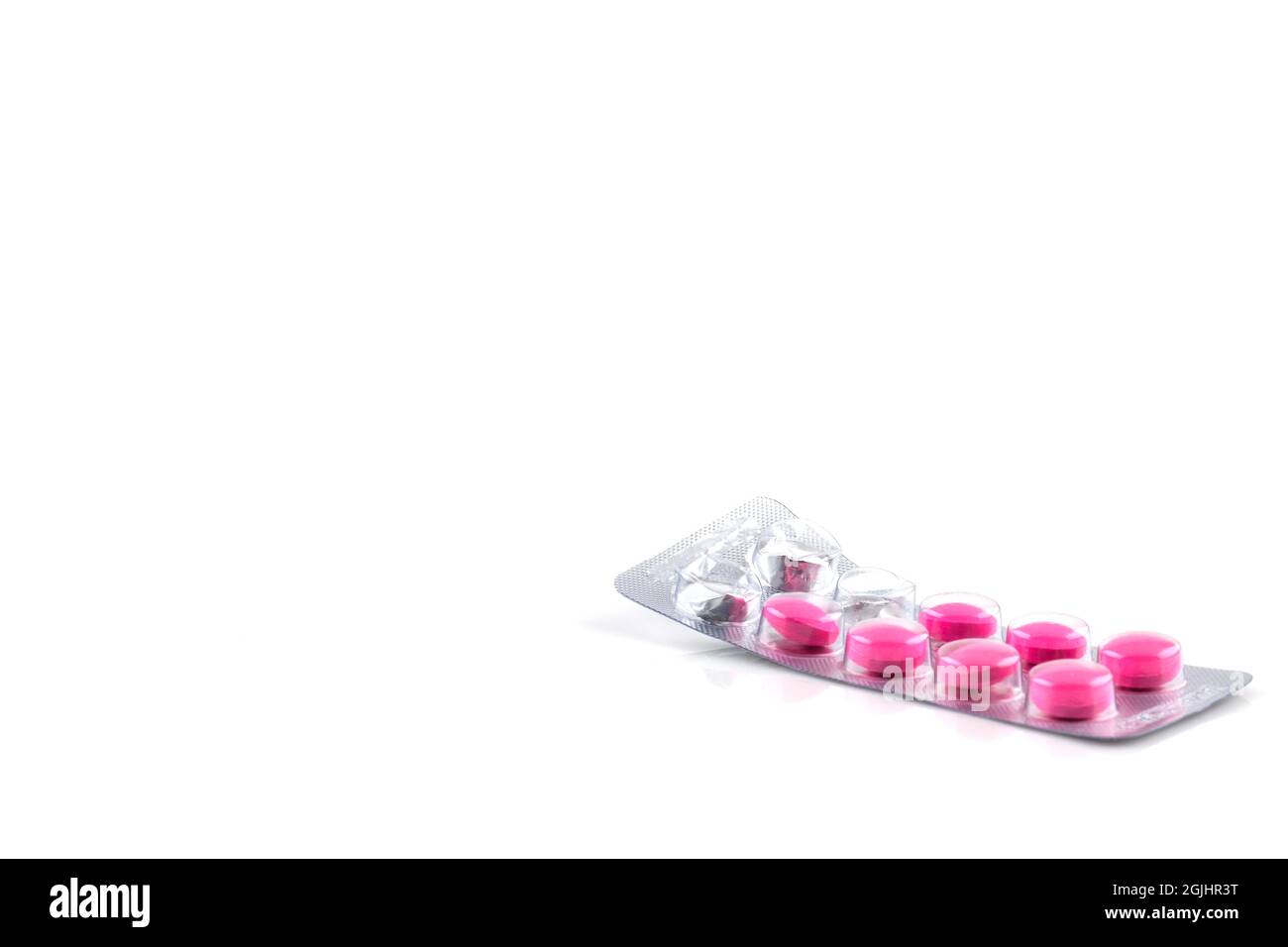 pink pills in package isolated on white background Stock Photo - Alamy