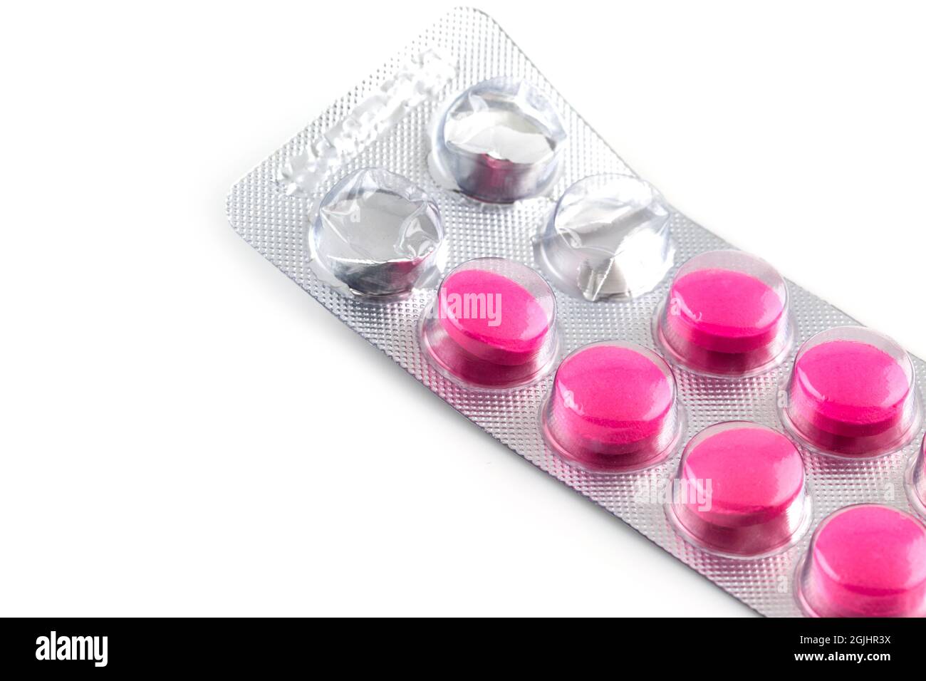 pink pills in package isolated on white background Stock Photo - Alamy