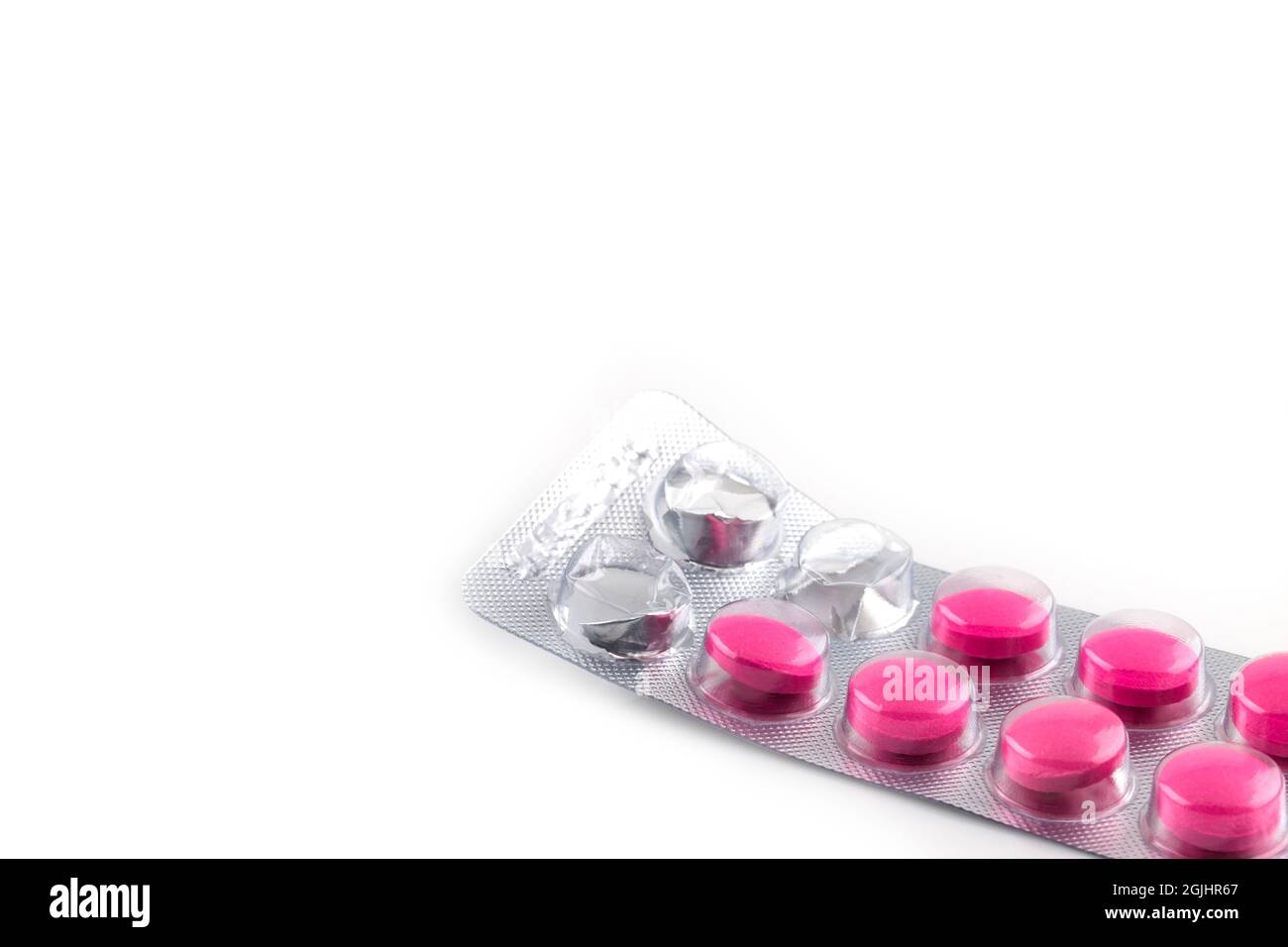 pink pills in package isolated on white background Stock Photo - Alamy