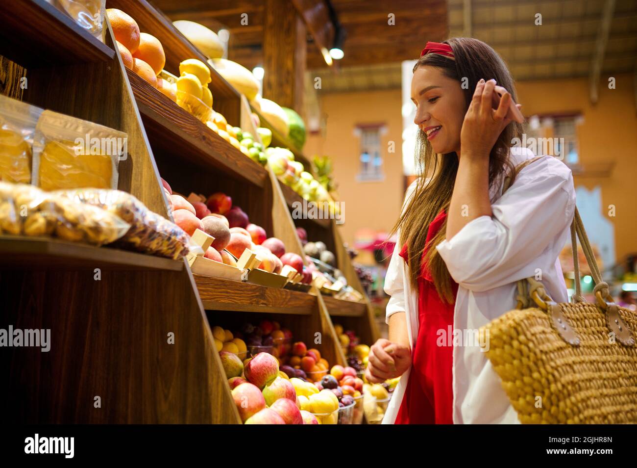 A female client choosing fruits in a vegetable store Stock Photo - Alamy