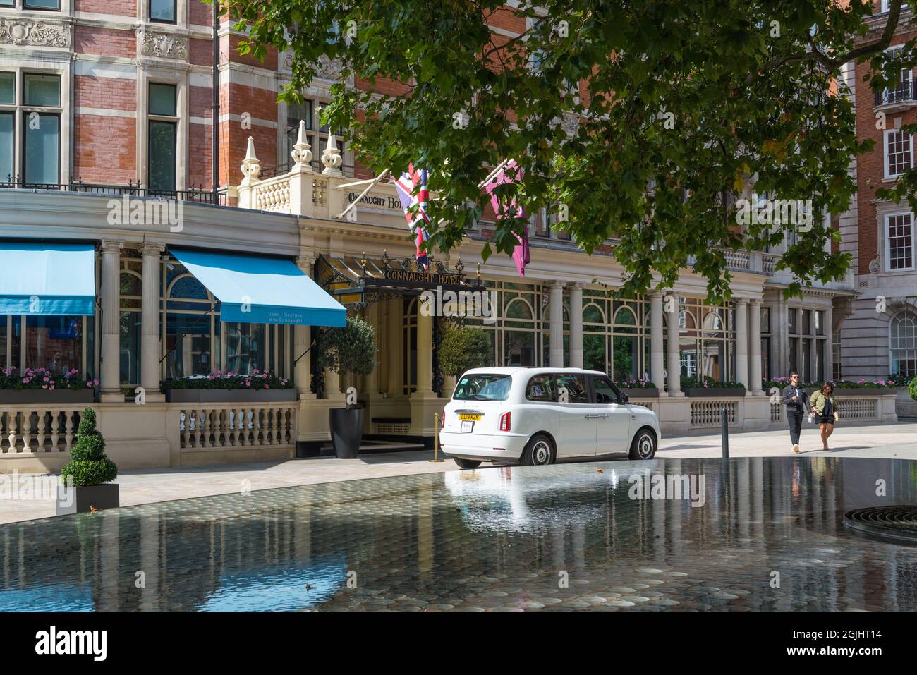 White taxi arriving outside the main entrance to the Connaught Hotel ...