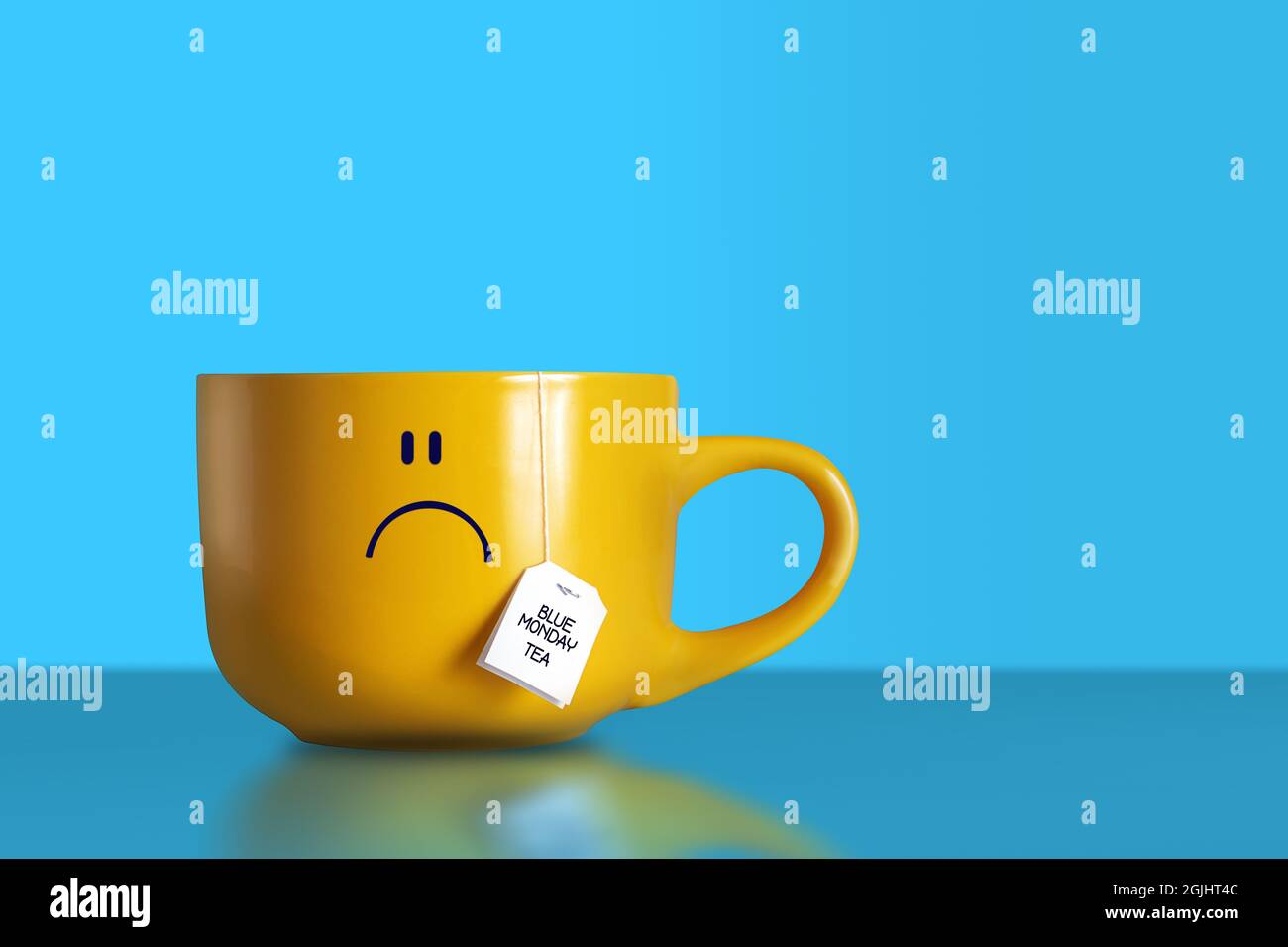 Blue monday tea. Big sad yellow cup Stock Photo - Alamy
