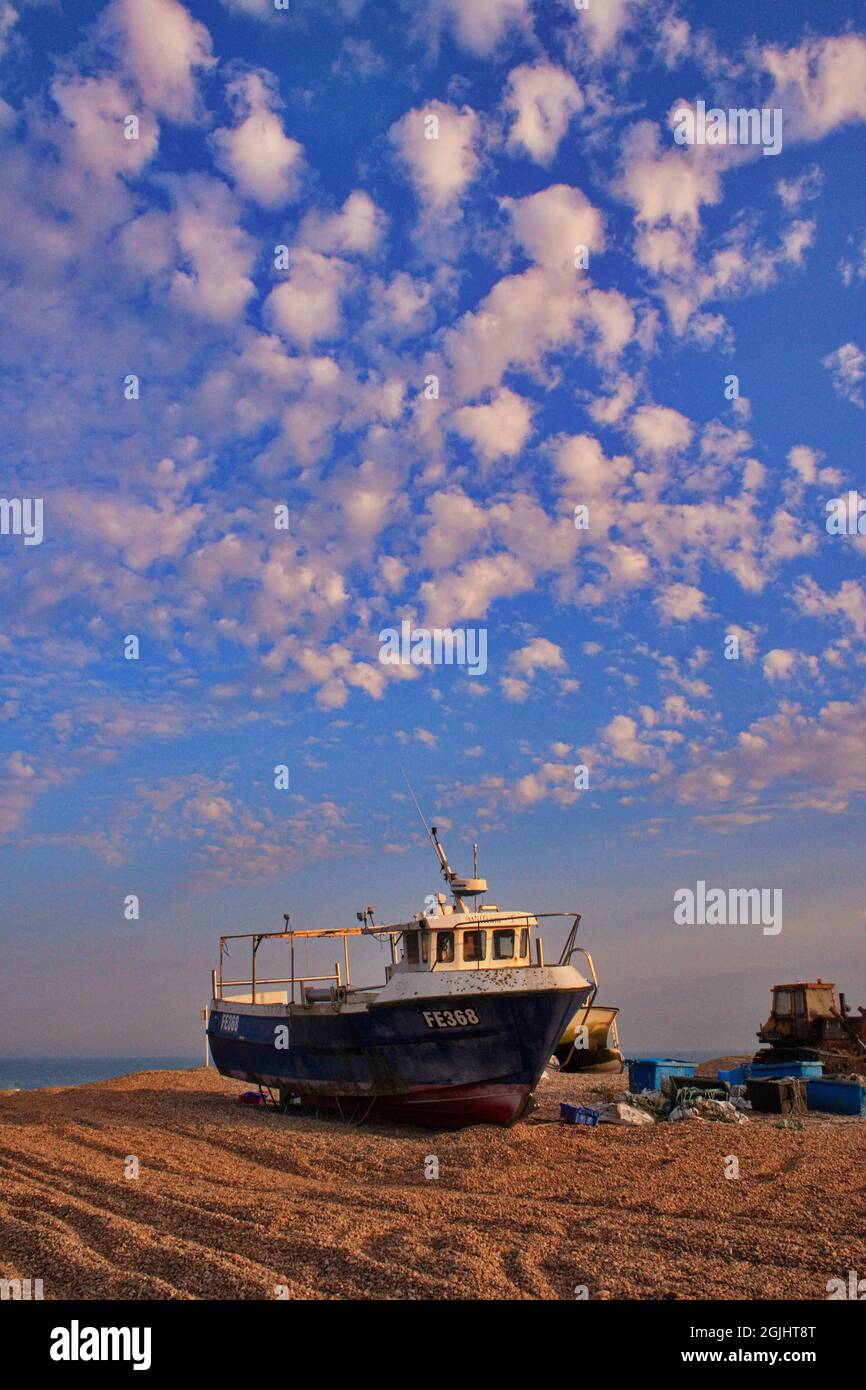 Picture of a Fishing Boats on a pebble beach with dramatic clouds Stock ...