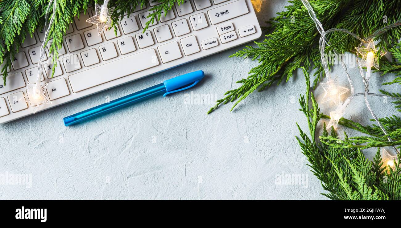 Workplace winter background with keyboard with green branches star ...