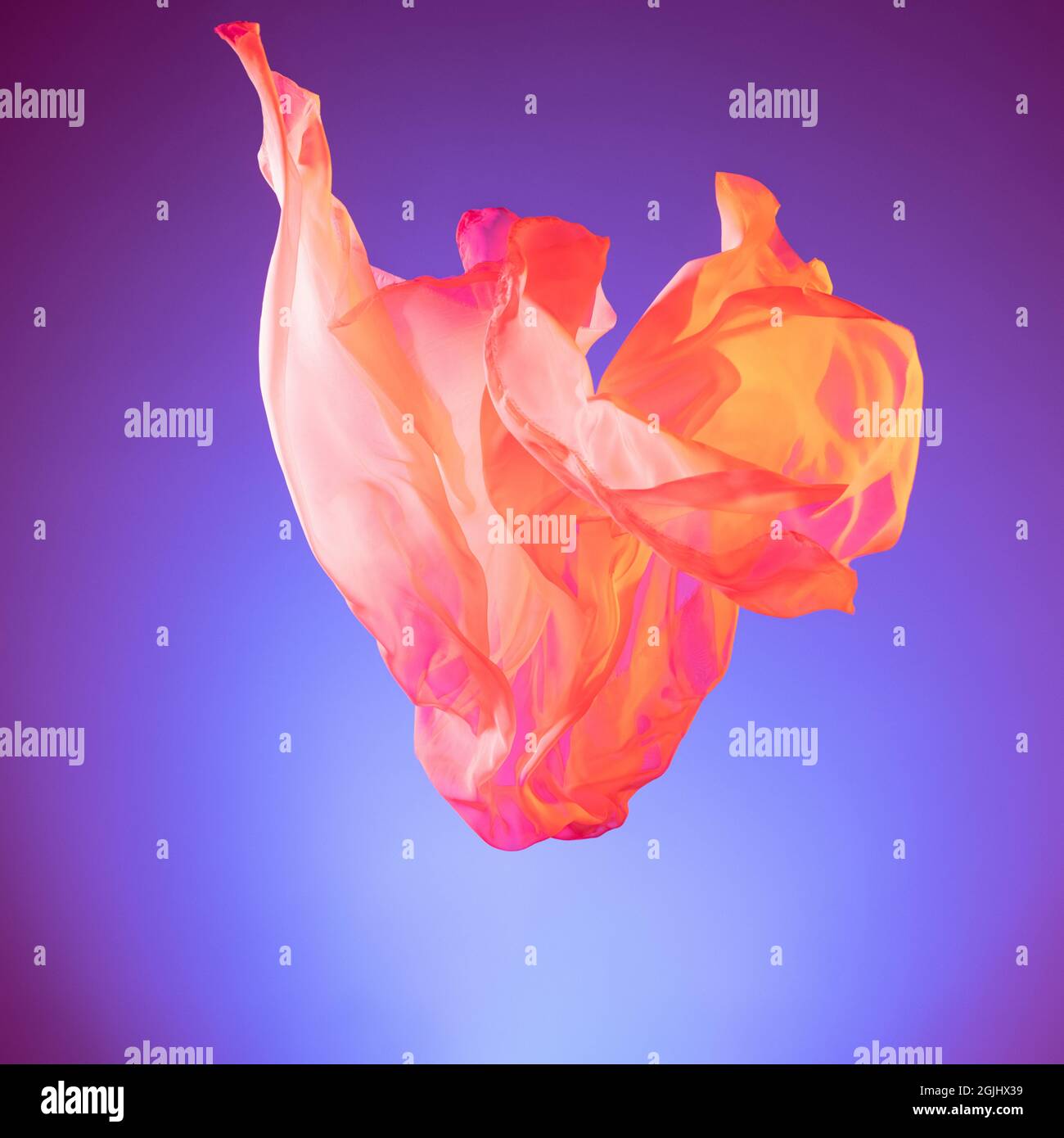 Elegant transparent pink orange flying piece of fabric isolated over ...