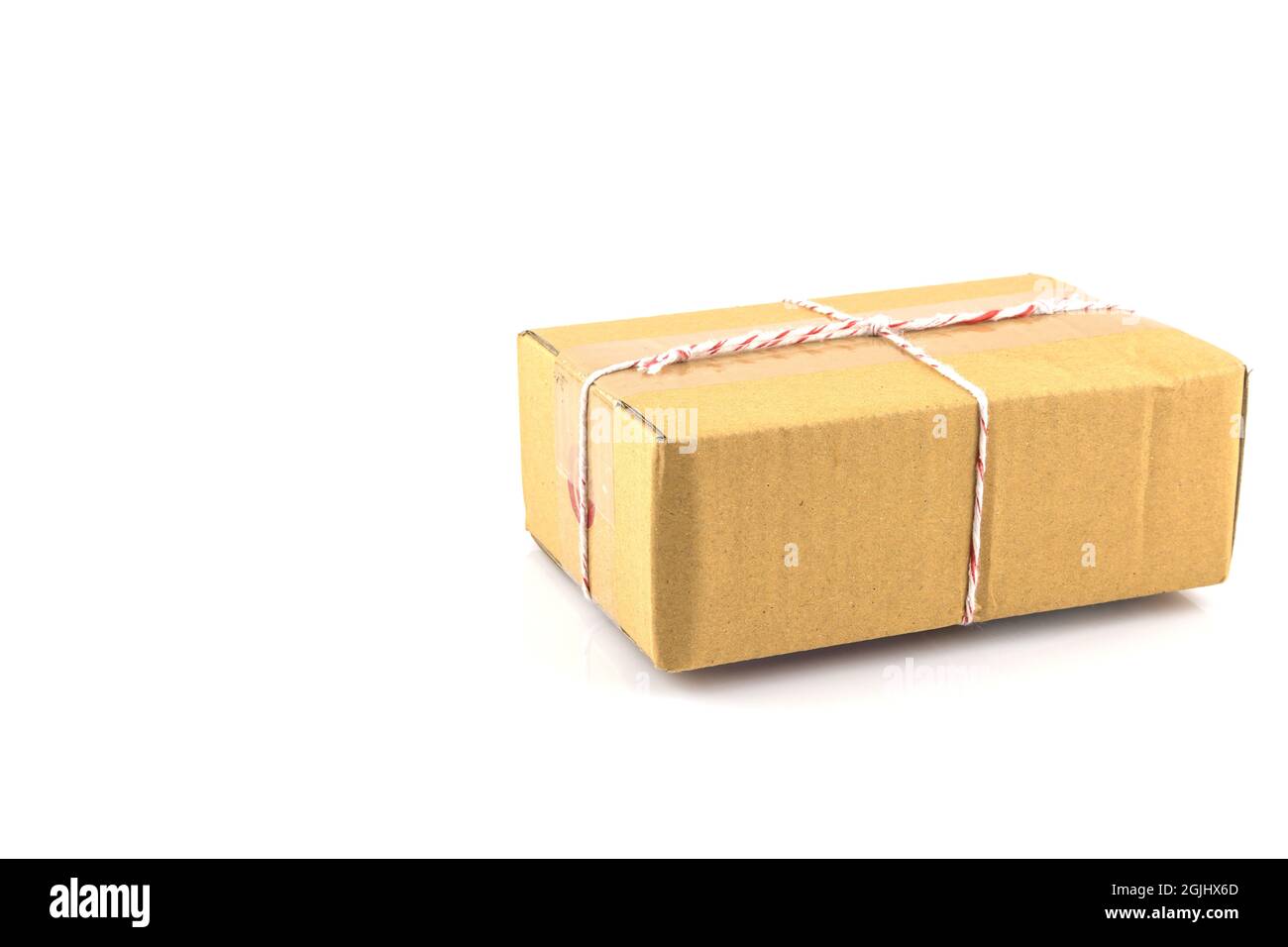 brown paper box tied with red and white string ready to send isolated ...