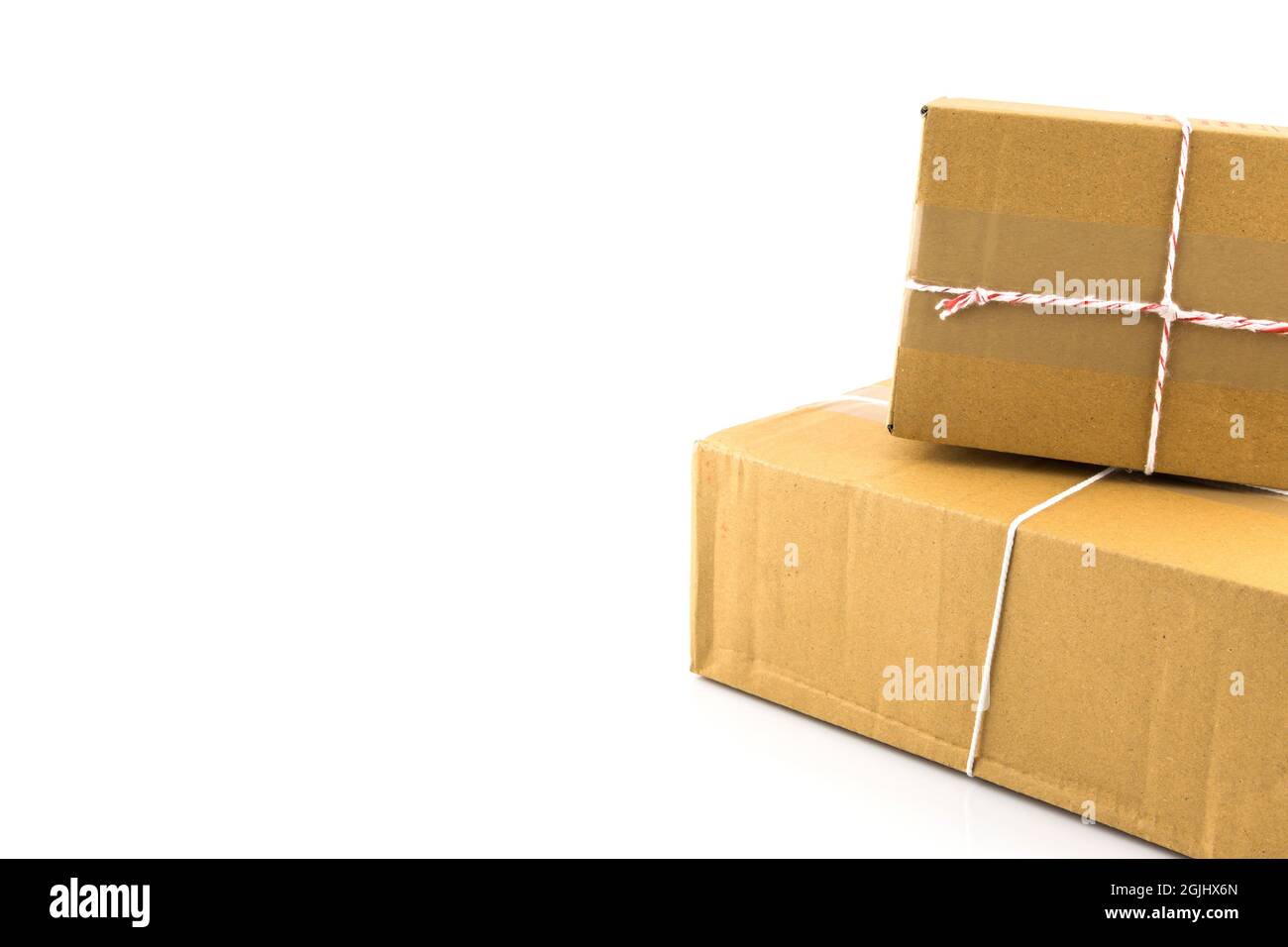 Two brown paper box tied with red and white string ready to send ...