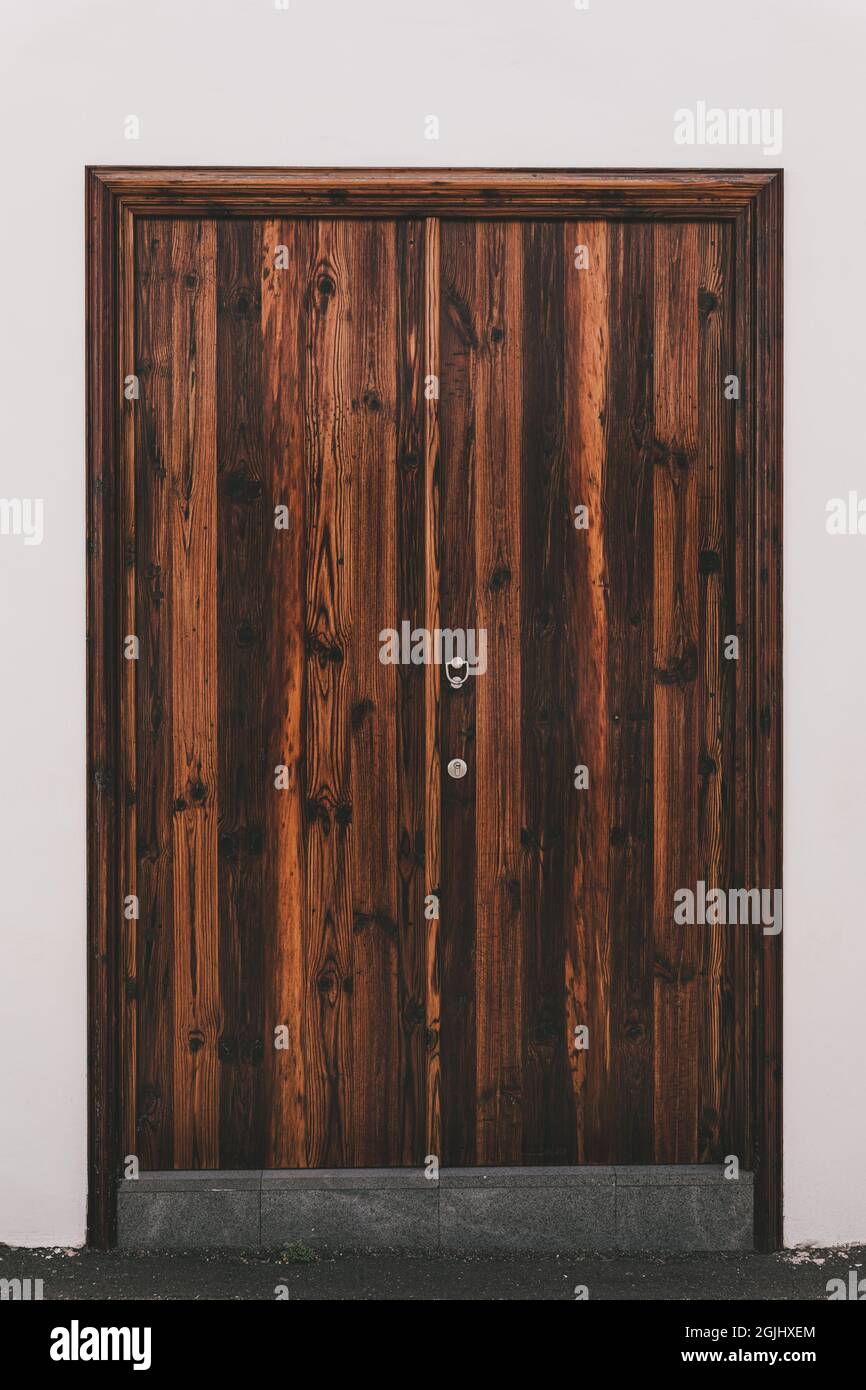 Modern wooden door of a white building Stock Photo - Alamy