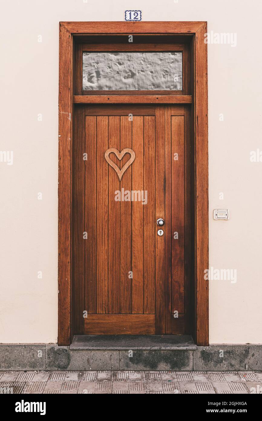 Modern wooden door with a heart carving Stock Photo - Alamy