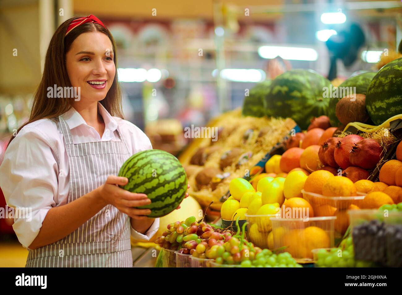 A cute seller selling watermelons in a vegetable store Stock Photo - Alamy