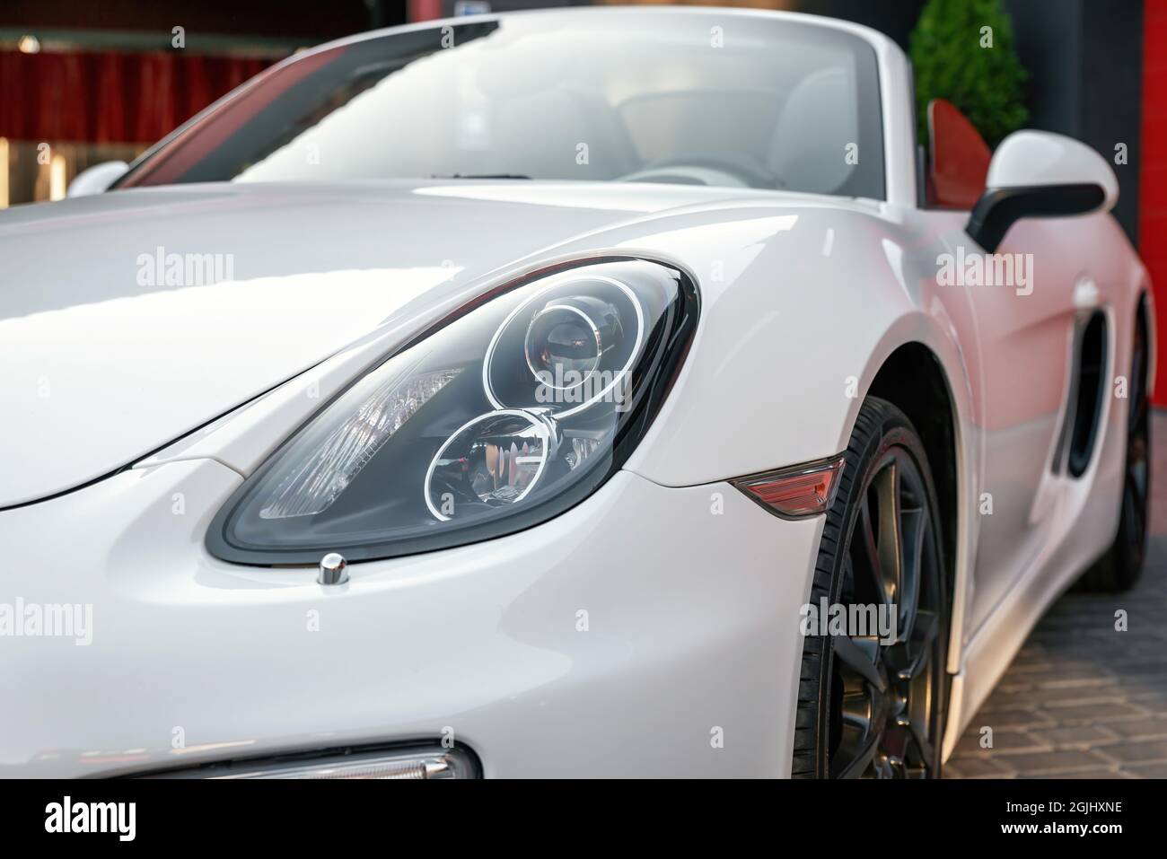 Part of white new modern car parking at the garage door. The automobile ...