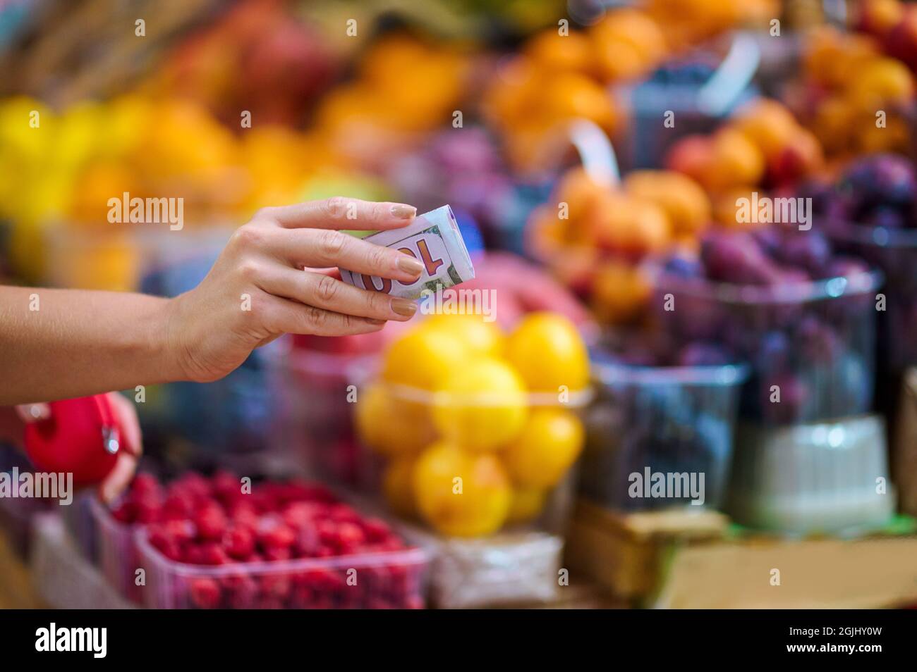 Close up picture of a female hand and lots of fruits Stock Photo - Alamy