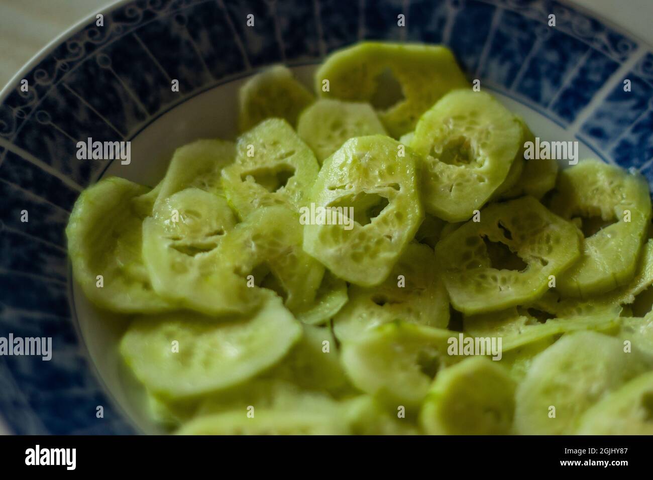 Close of sliced cucumbers on a plate Unusual cucumbers of funny shape ...