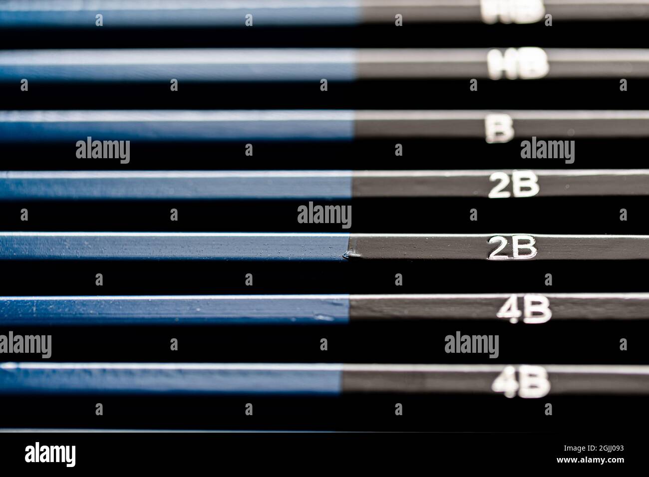 Selective focus on 2B pencil on full set of black and blue writing and ...