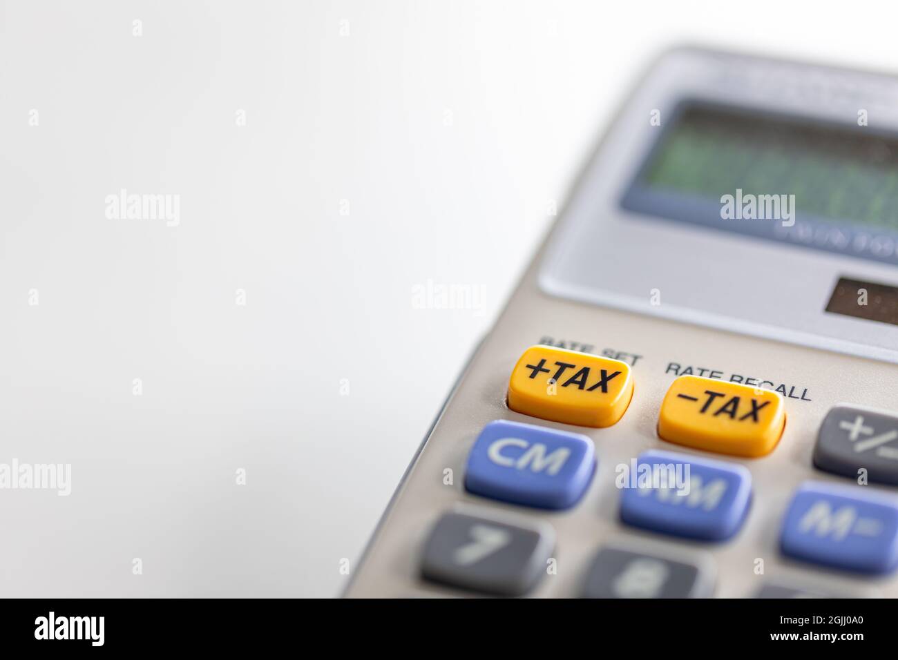 Selective focus on plus tax yellow button of calculator with blank ...