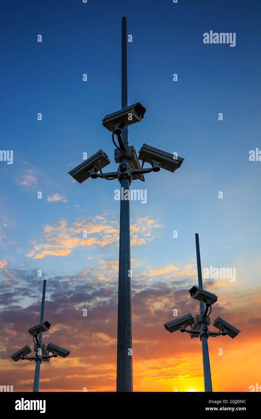 Many security cameras watching all around. CCTV equipment on dramatic ...