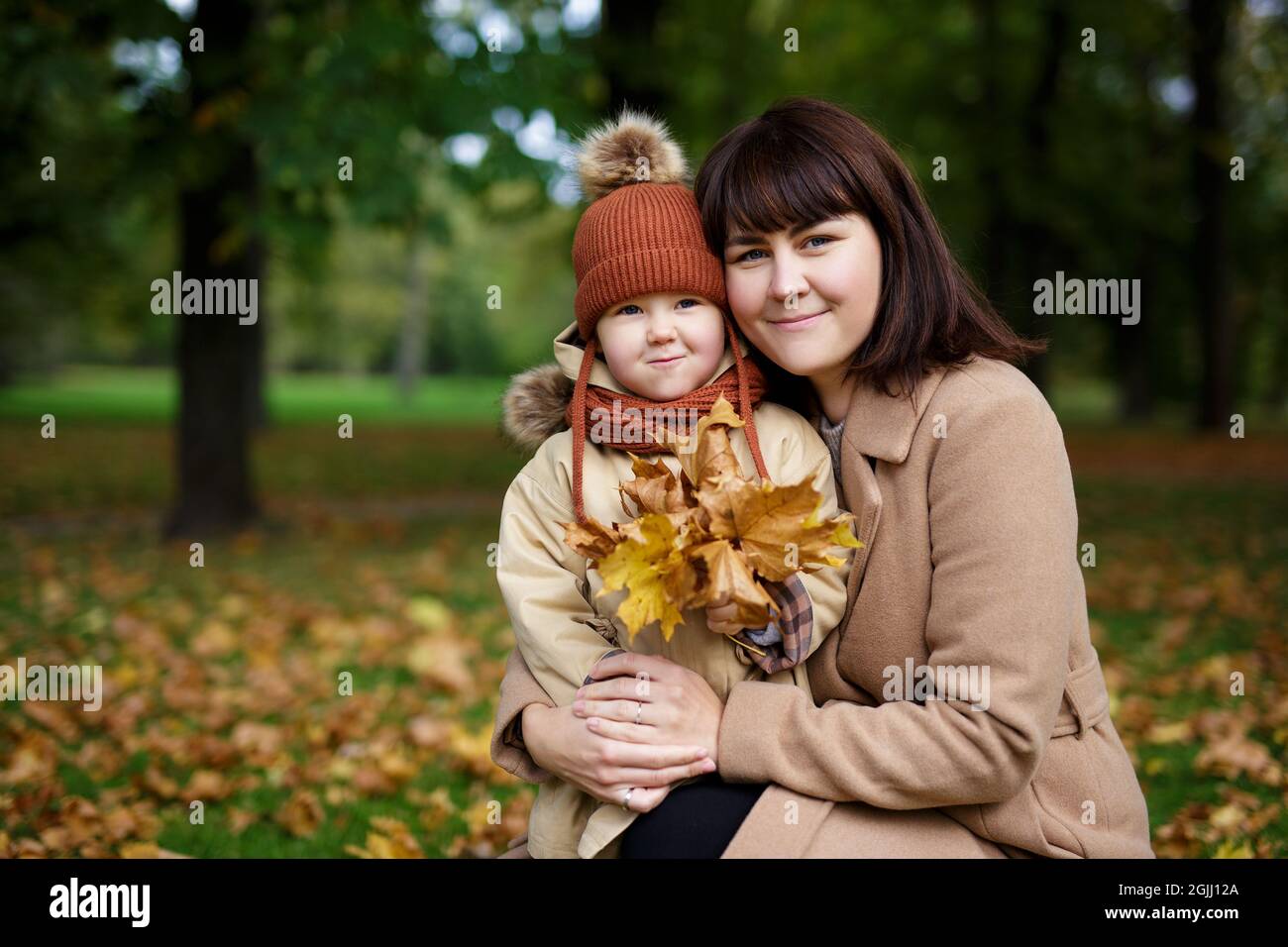 family, motherhood, love and care concept - portrait of mother and her ...