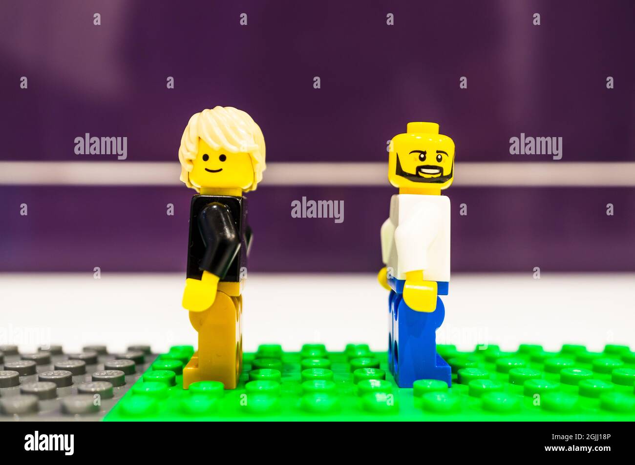 POZNAN, POLAND - May 13, 2020: Two Lego figurines standing with back to ...