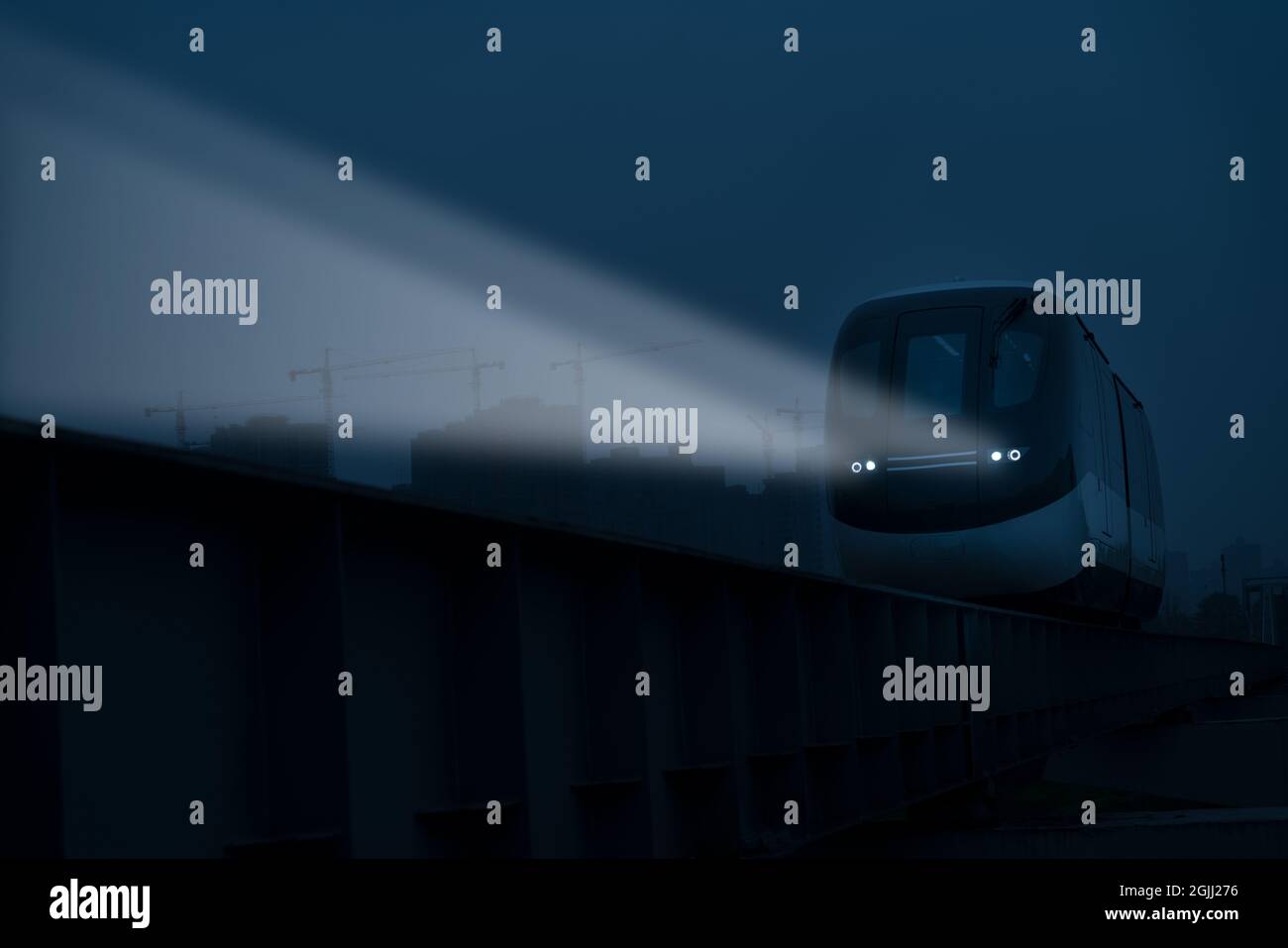 Train with illuminated headlights at night time Stock Photo - Alamy