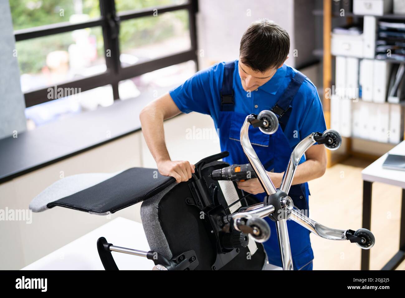 Office Chair Assembling And Repair. Man Working With Tool Stock Photo ...