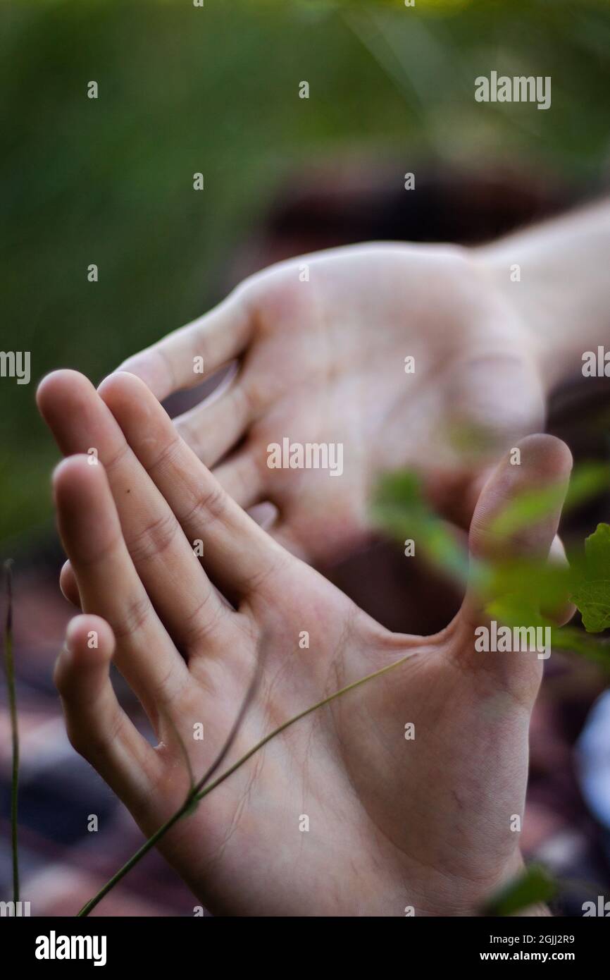Laying man raising hands in a defensive gesture | Close up of hands of ...