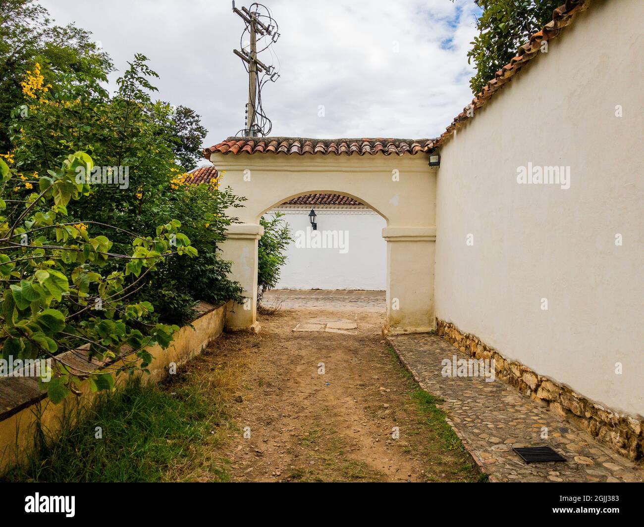 Beautiful view of a building garden with an arc and plants Stock Photo ...