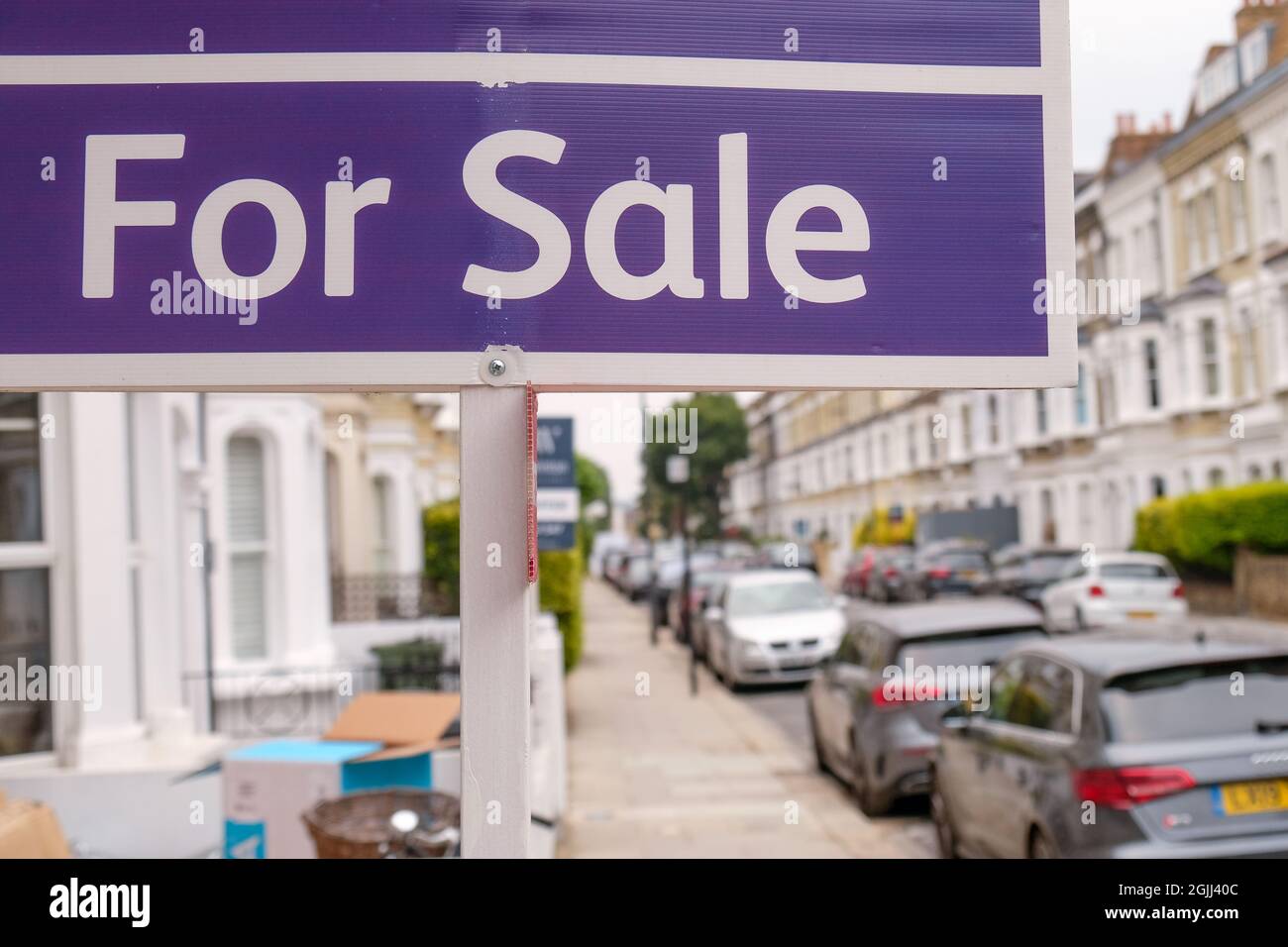 Estate agent For Sale sign on street of houses Stock Photo - Alamy