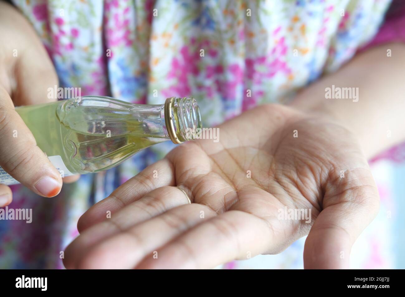 pouring hair oil on hand close up Stock Photo - Alamy