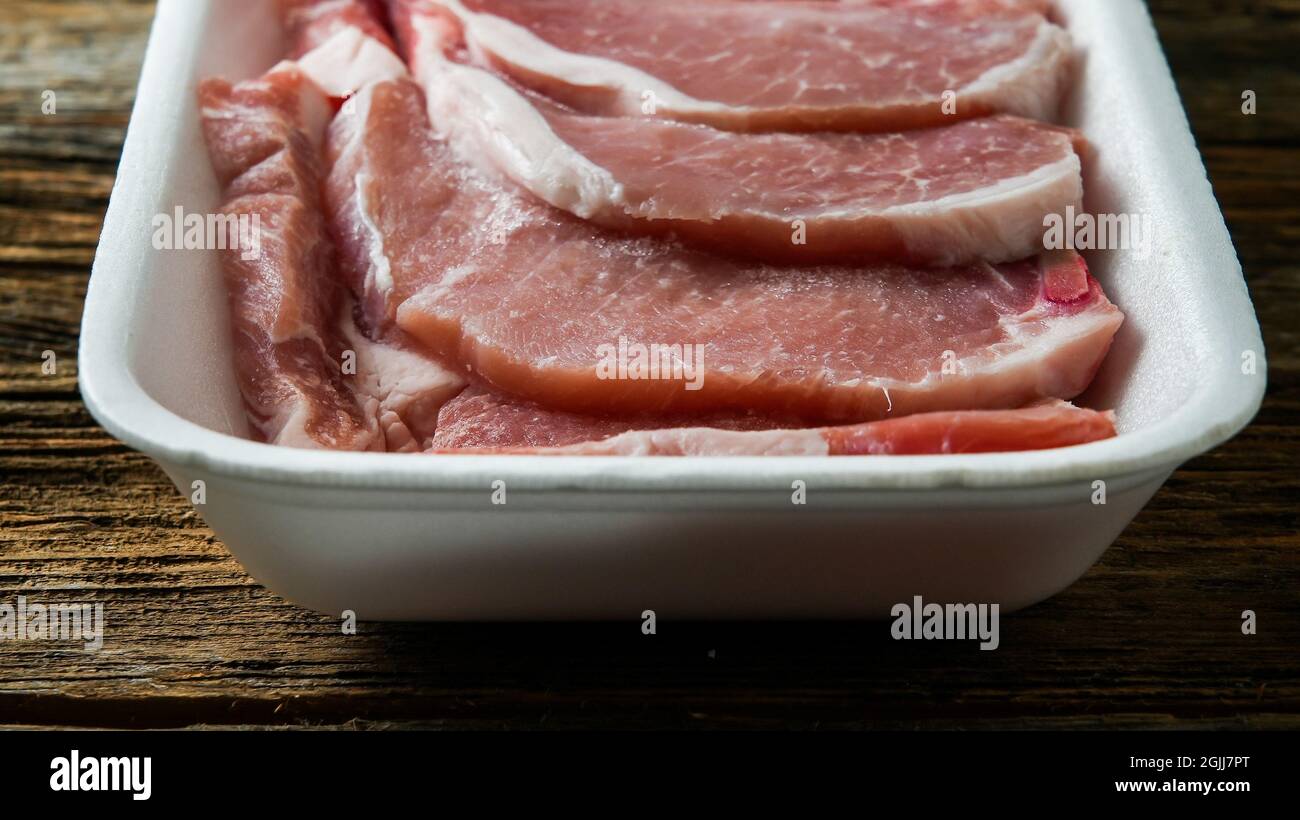 Pork meat inside styrofoam try in rustic wooden background Stock Photo ...