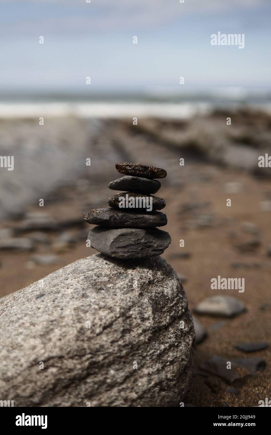 Different size and shape stone on each other with the rocky shore in ...