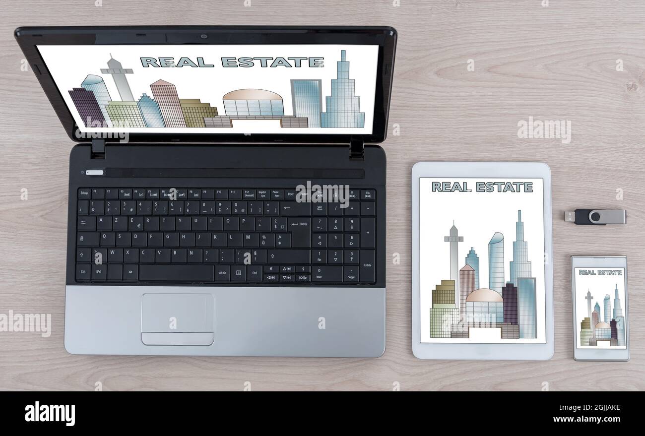 Real estate concept shown on different information technology devices ...