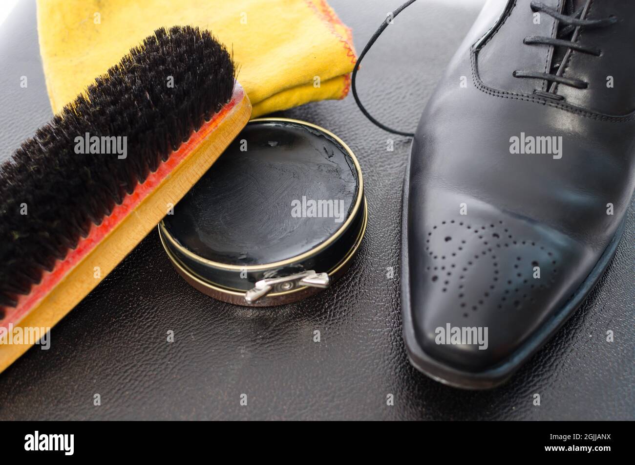 Shoe polish,brush, rag and black shoe Stock Photo - Alamy