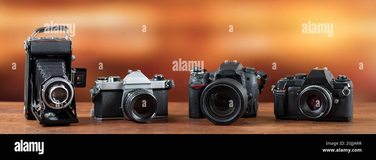 Group of cameras from different generations on blurred background Stock ...