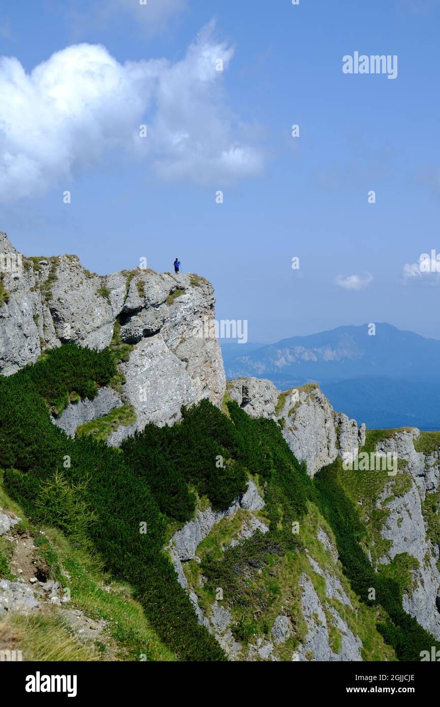 Hiking on the ridge of the amazing rocks of the Caraiman Peak, Bucegi ...