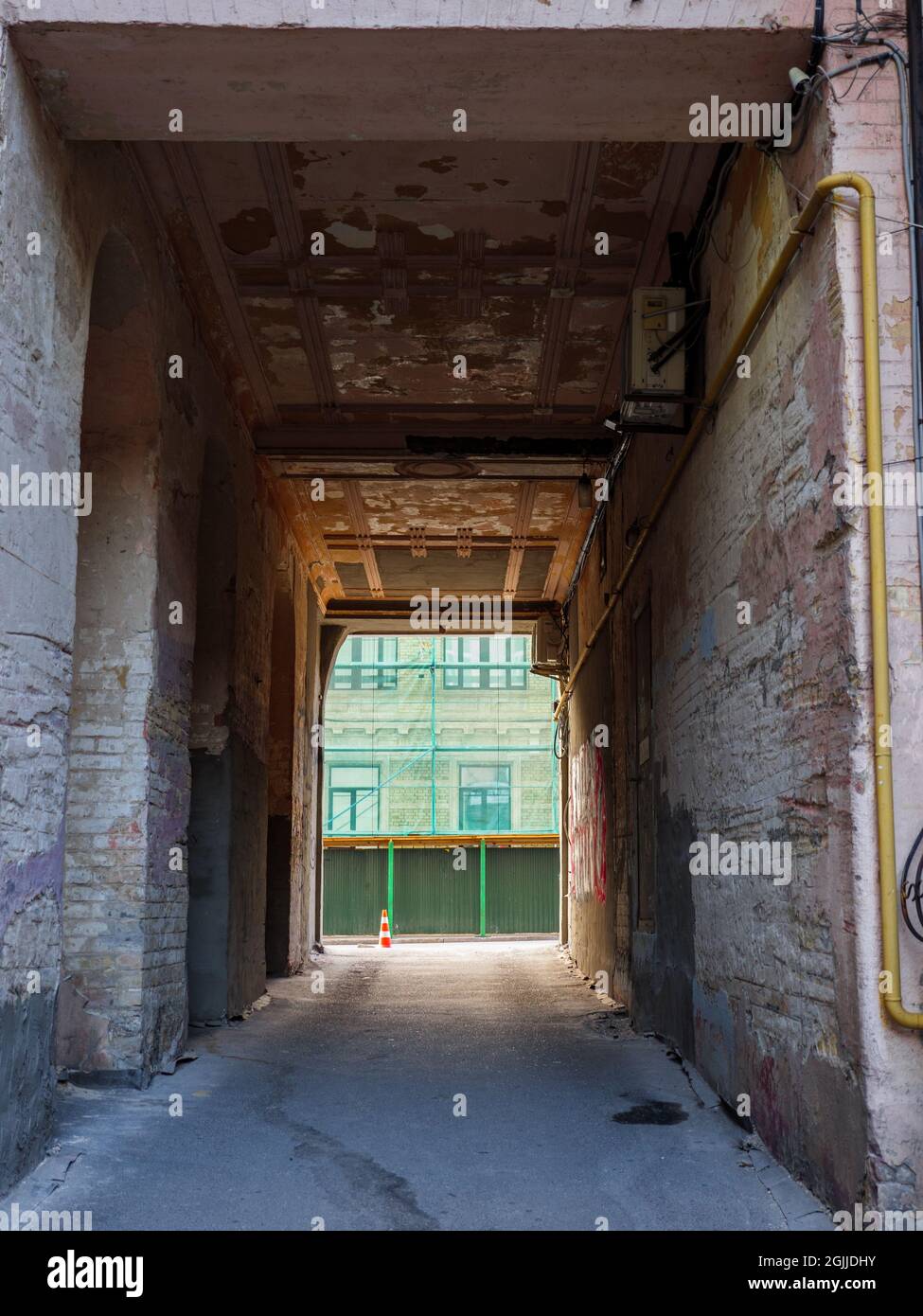Archway through the old ancient time-worn brick building with view over ...