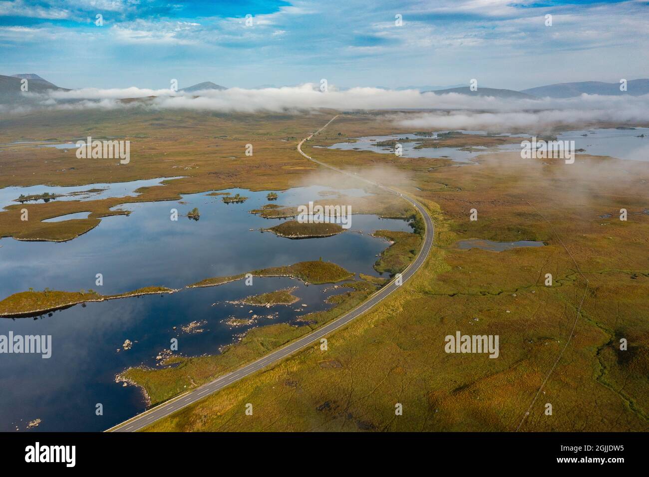 Early morning view of Rannoch Moor and A82 road in the mist from drone ...
