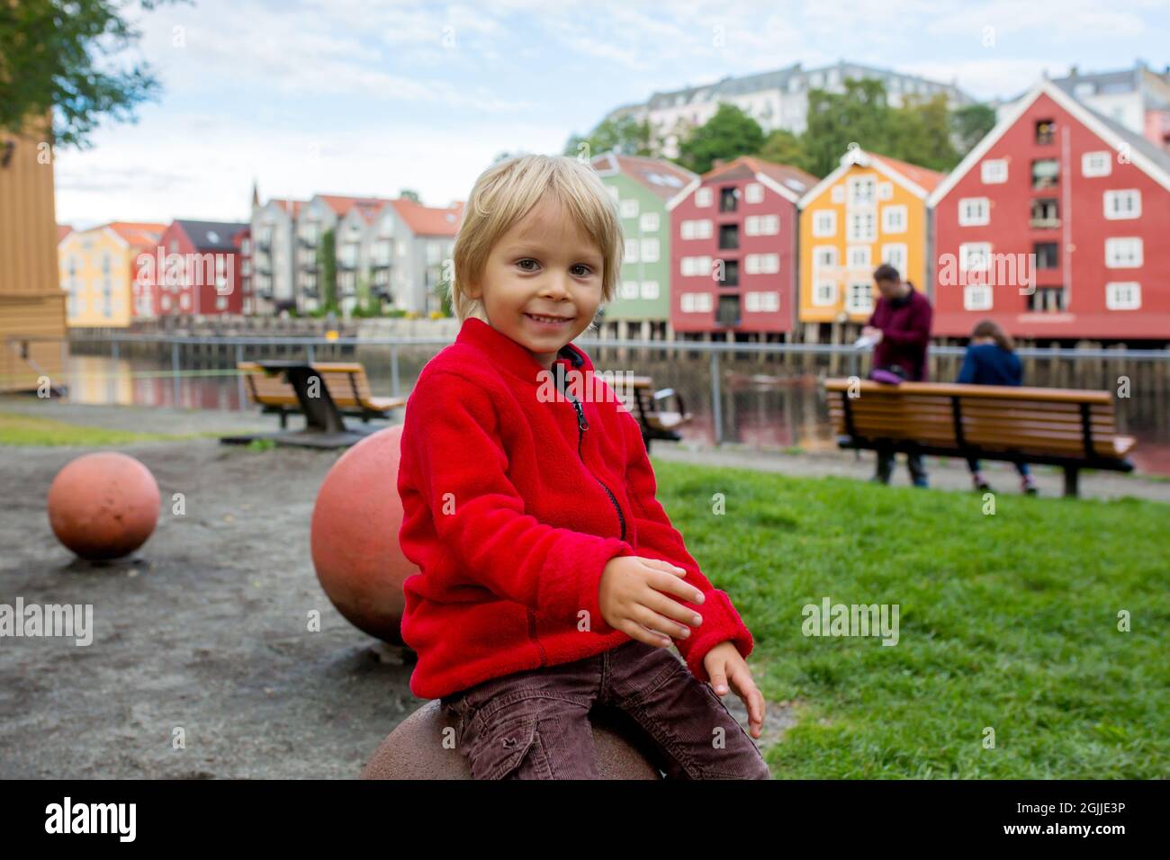 Cute child, boy, visiting Trondheim, Norway during the summer, enjoying ...