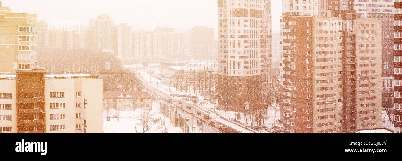 winter city landscape with falling snow. view of the town from a height ...