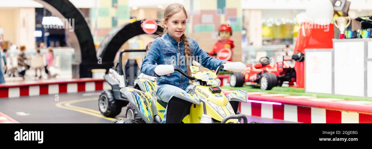 Moscow, Russia, 28 May 2021 - little happy kid girl fun riding an small ...