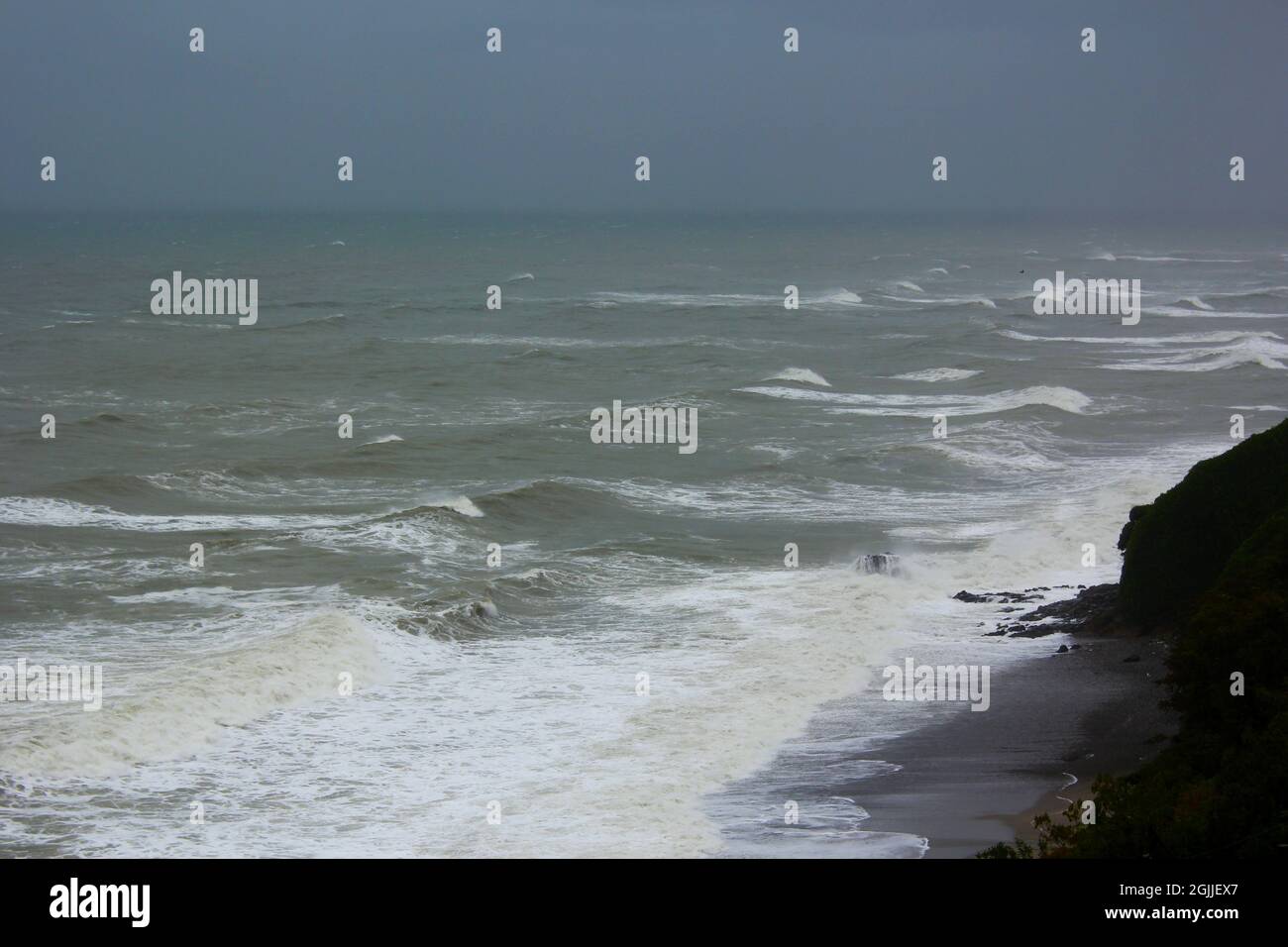 Beautiful seascape with foamy water on the background of the gloomy sky ...