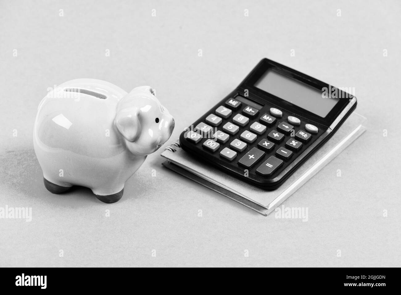 Family counting money piggy bank Black and White Stock Photos & Images ...