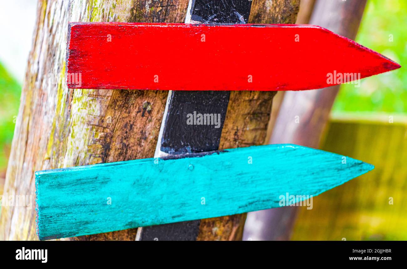 Colorful plain directional wooden arrows on tropical island Ilha Grand ...