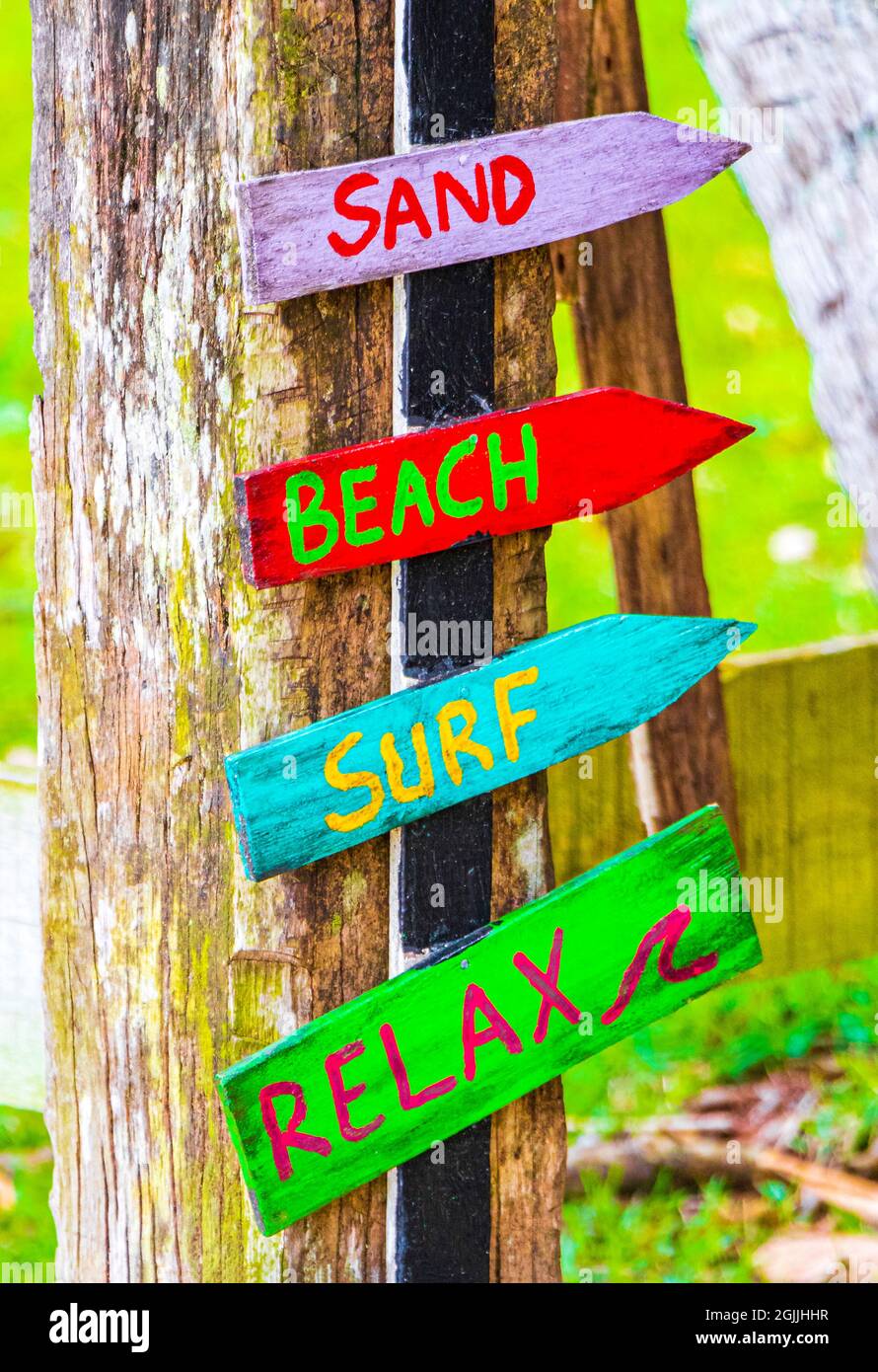 Sand beach surf and relax on colorful directional wooden arrows on the ...