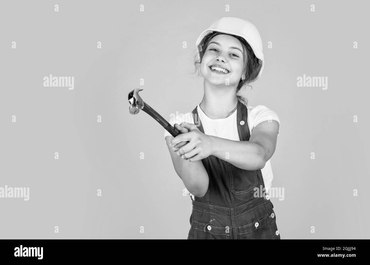 cheerful child laborer using building uniform and hammer tool, tool ...